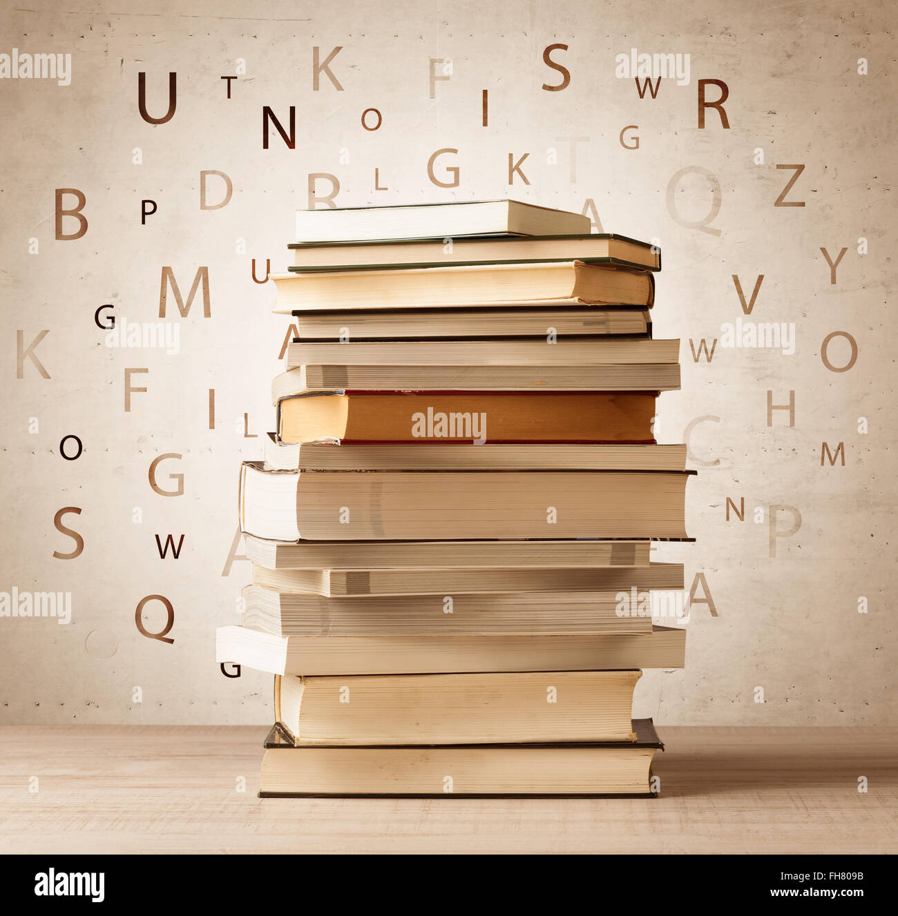 Books with flying letters on vintage background Stock Photo - Alamy