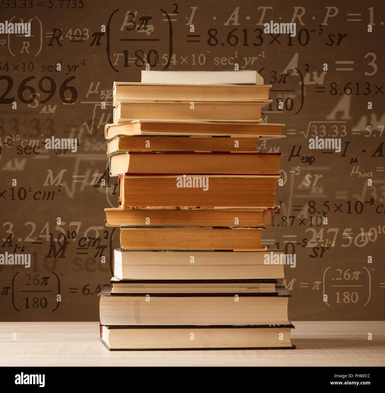 Books on vintage background with math formulas Stock Photo - Alamy