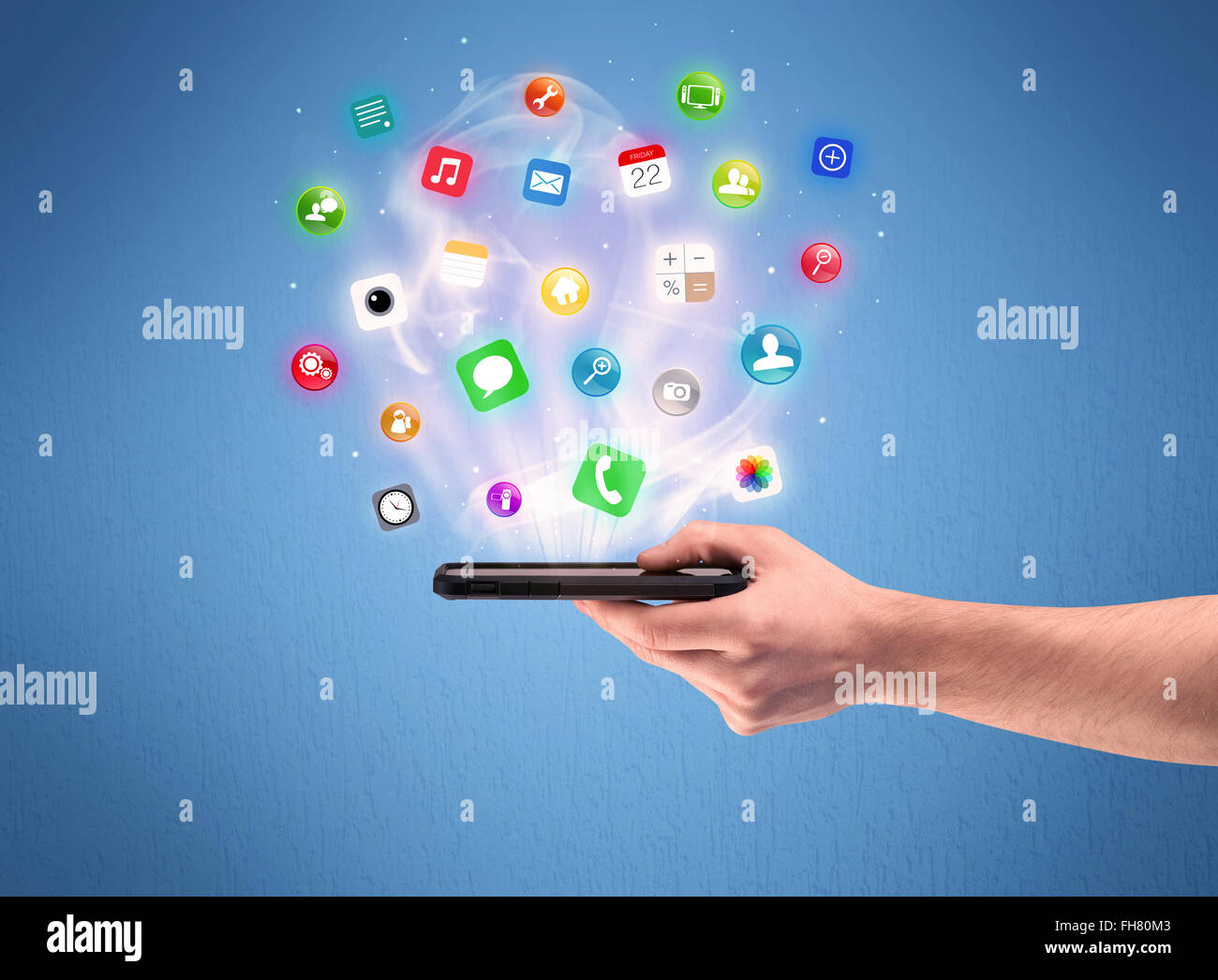Hand holding tablet phone with app icons Stock Photo - Alamy