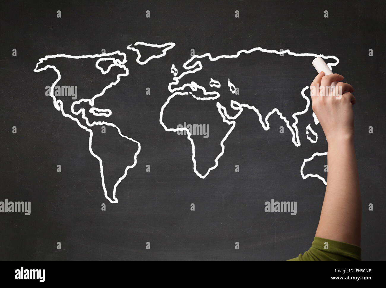Adult drawing world map on chalkboard Stock Photo - Alamy