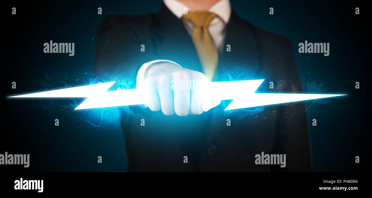 Business man holding glowing lightning bolt in his hands Stock Photo ...