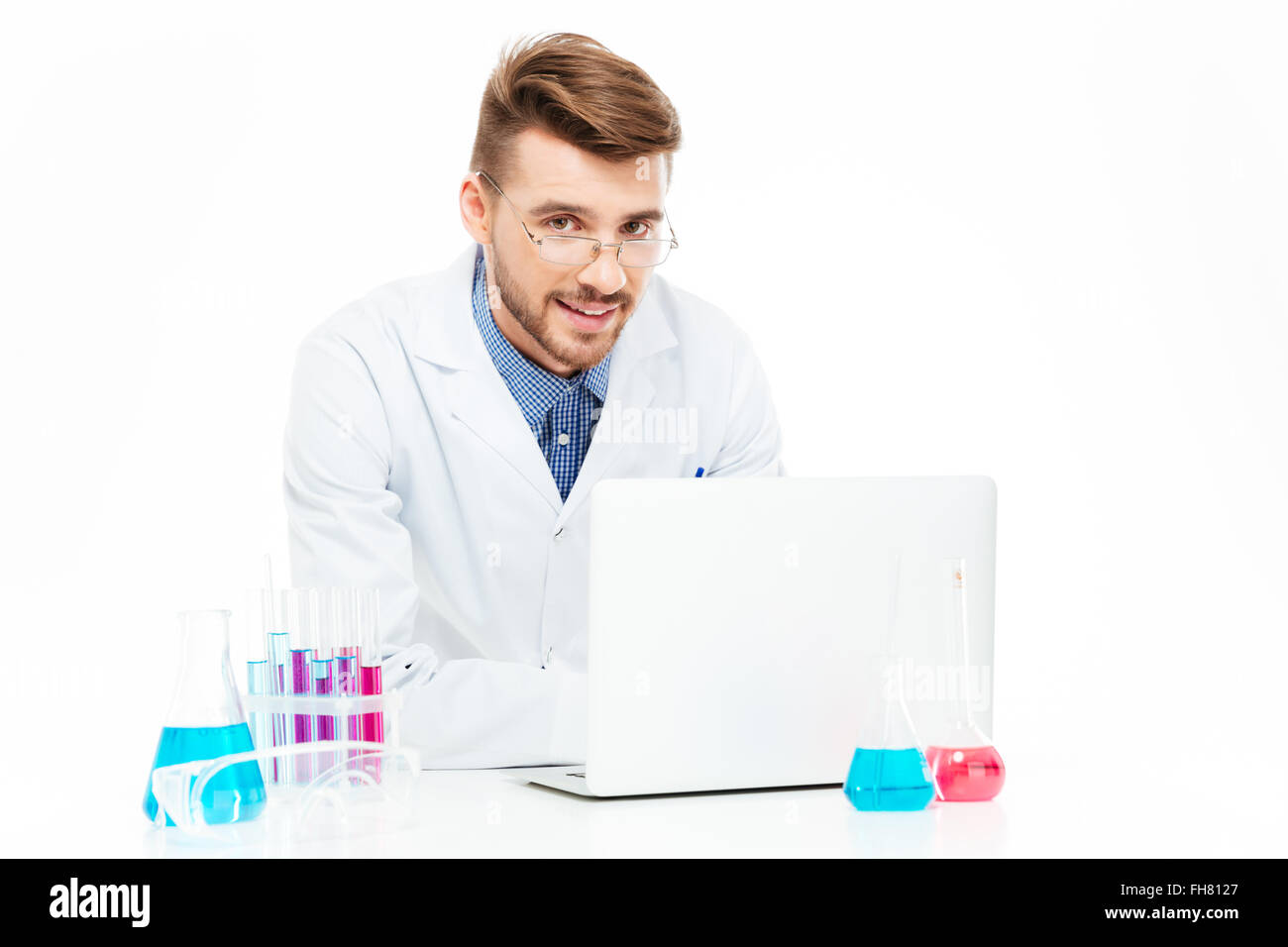 Happy chemist using laptop computer in laboratory Stock Photo - Alamy