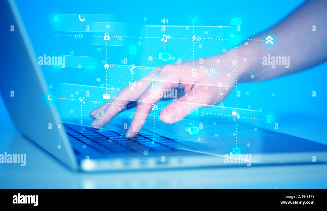 Hand pressing keyboard with high tech media icons Stock Photo - Alamy