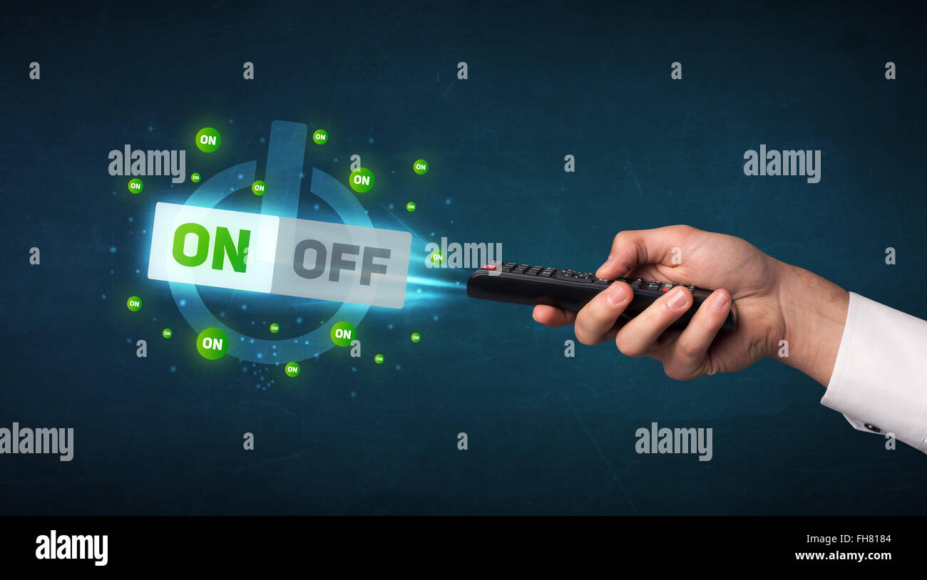 Hand with remote control and on-off signals Stock Photo - Alamy