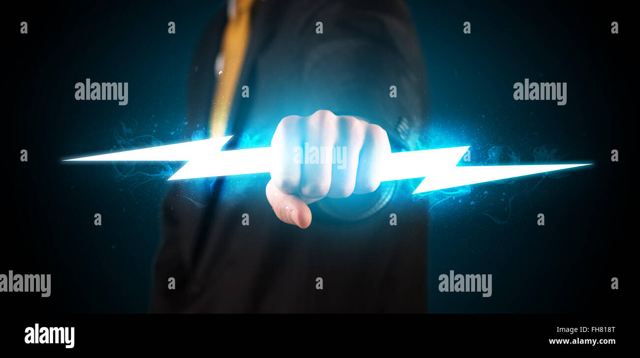 Business man holding glowing lightning bolt in his hands Stock Photo ...