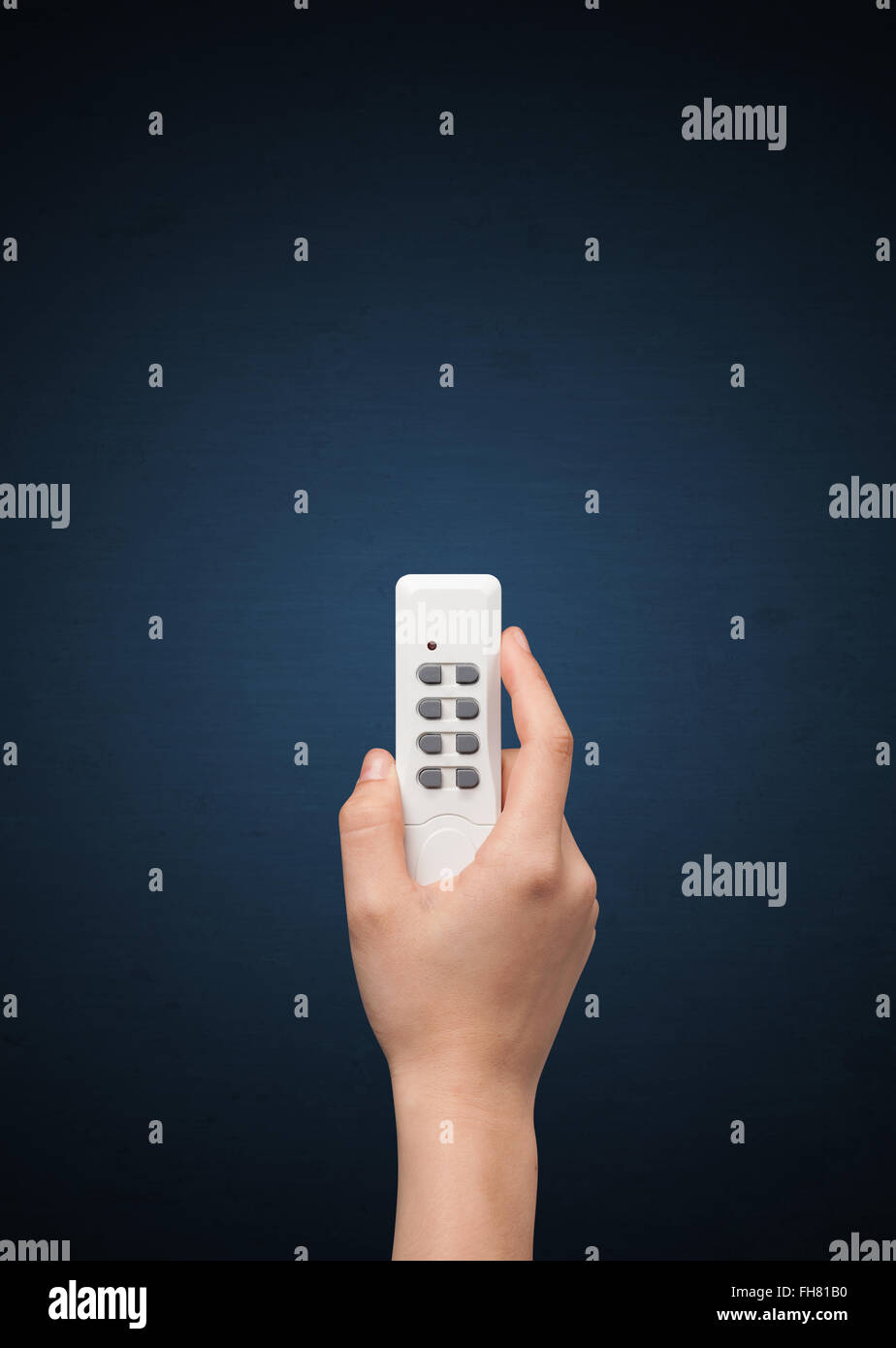 Hand with remote control Stock Photo - Alamy