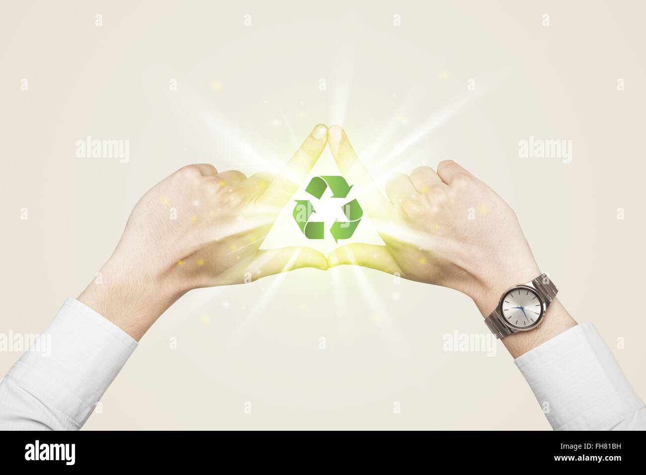 Hands creating a form with recycling sign Stock Photo - Alamy