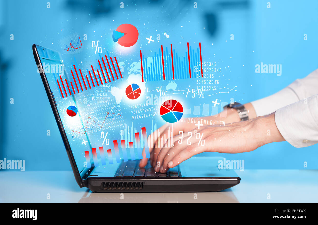 Hand typing on modern laptop notebook computer with graph icons and ...