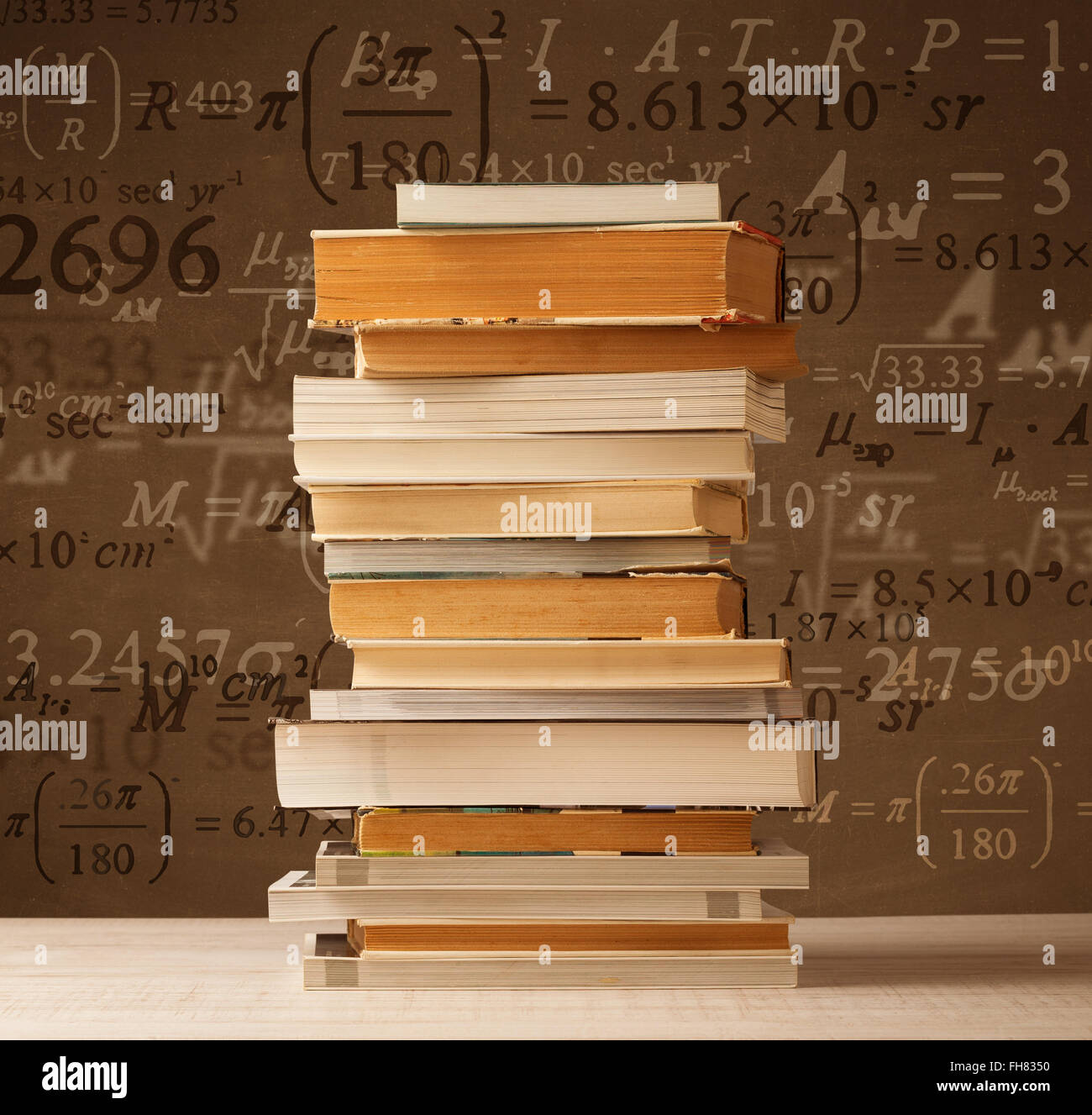 Books on vintage background with math formulas Stock Photo - Alamy