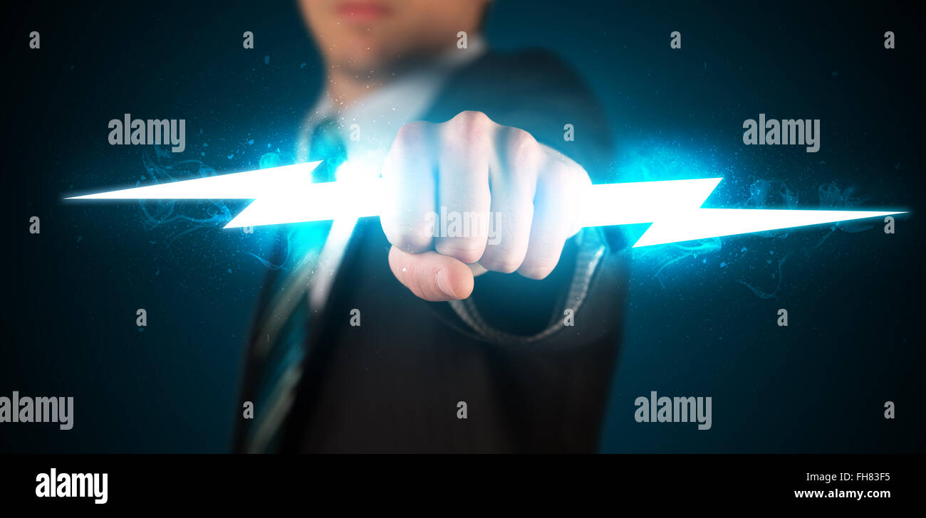 Business man holding glowing lightning bolt in his hands Stock Photo ...