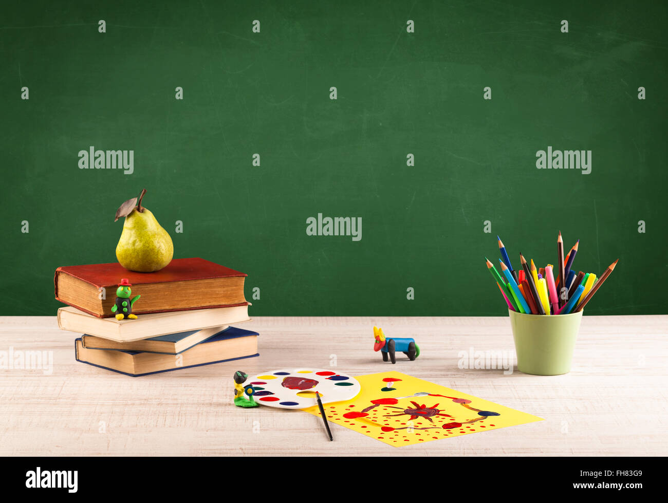 School items on desk with empty chalkboard Stock Photo - Alamy
