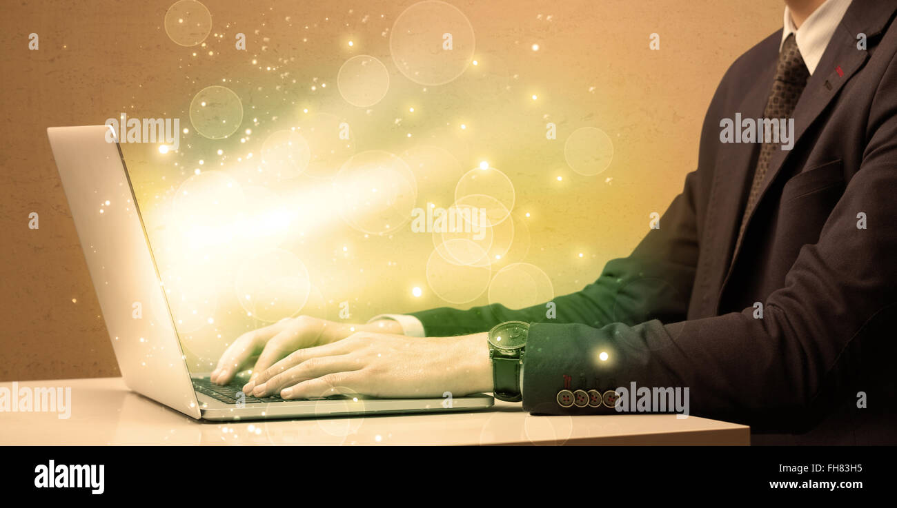 Businessman working fast on laptop Stock Photo - Alamy