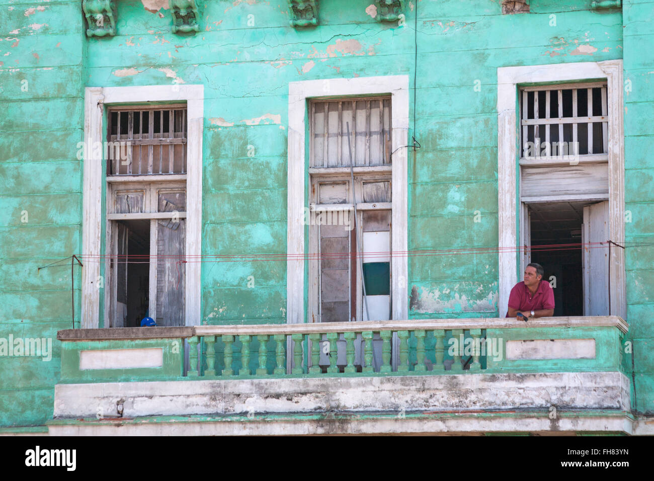 Daily life in Cuba - Cuban man leaning on balcony at Havana, Cuba, West ...