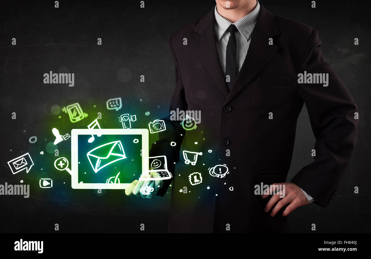Person holding a tablet with media icons and symbols Stock Photo - Alamy