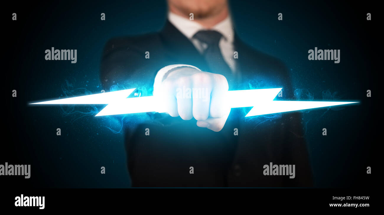Business man holding glowing lightning bolt in his hands Stock Photo ...