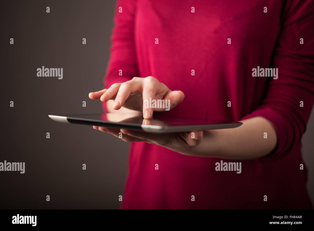 Close up of hand holding digital touchpad tablet device Stock Photo - Alamy
