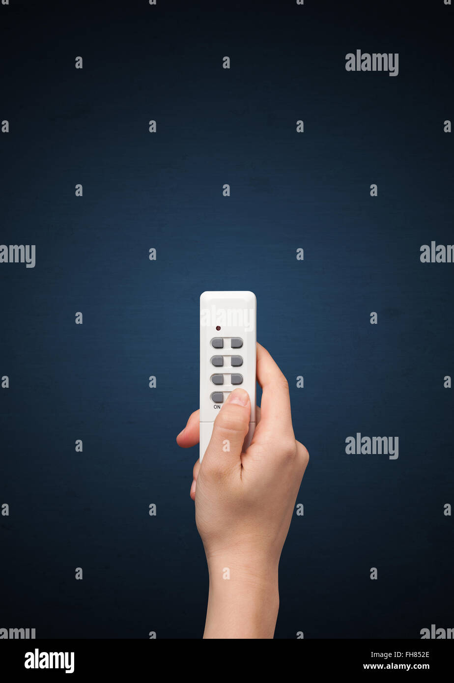 Hand with remote control Stock Photo - Alamy