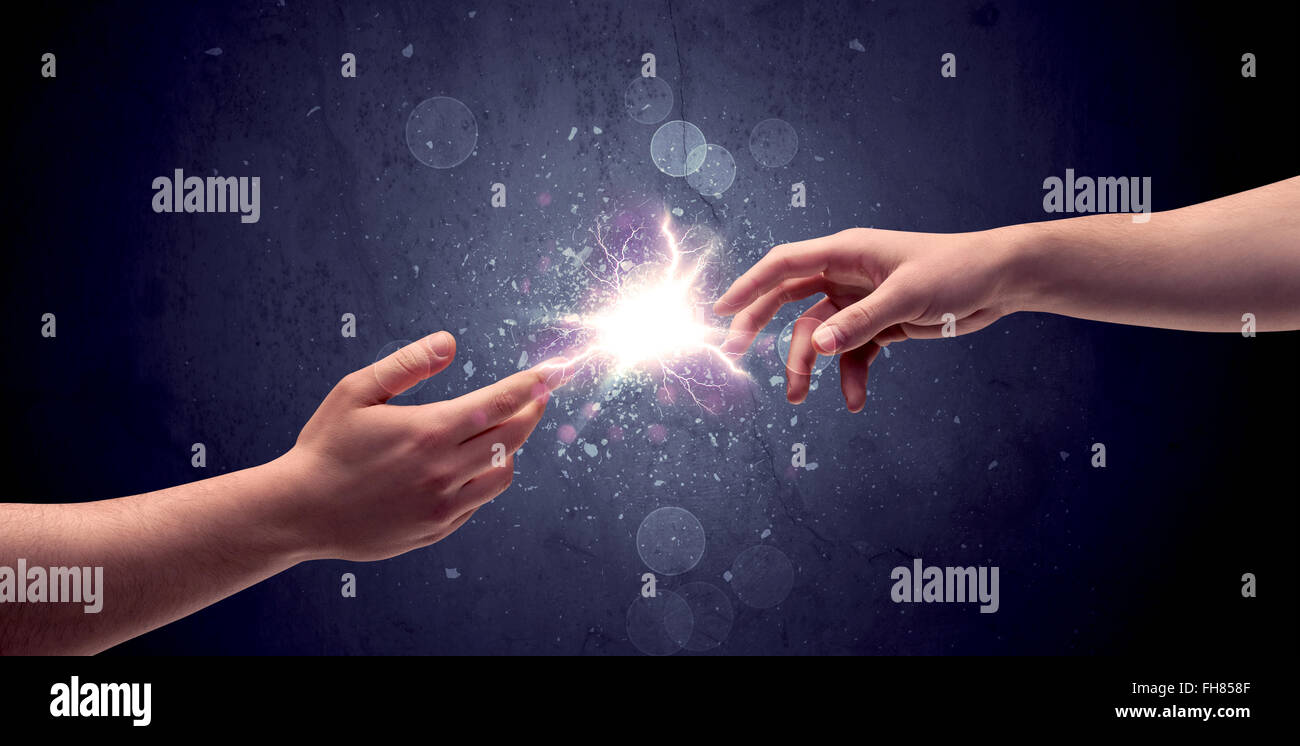 Hands reaching to light a spark Stock Photo - Alamy