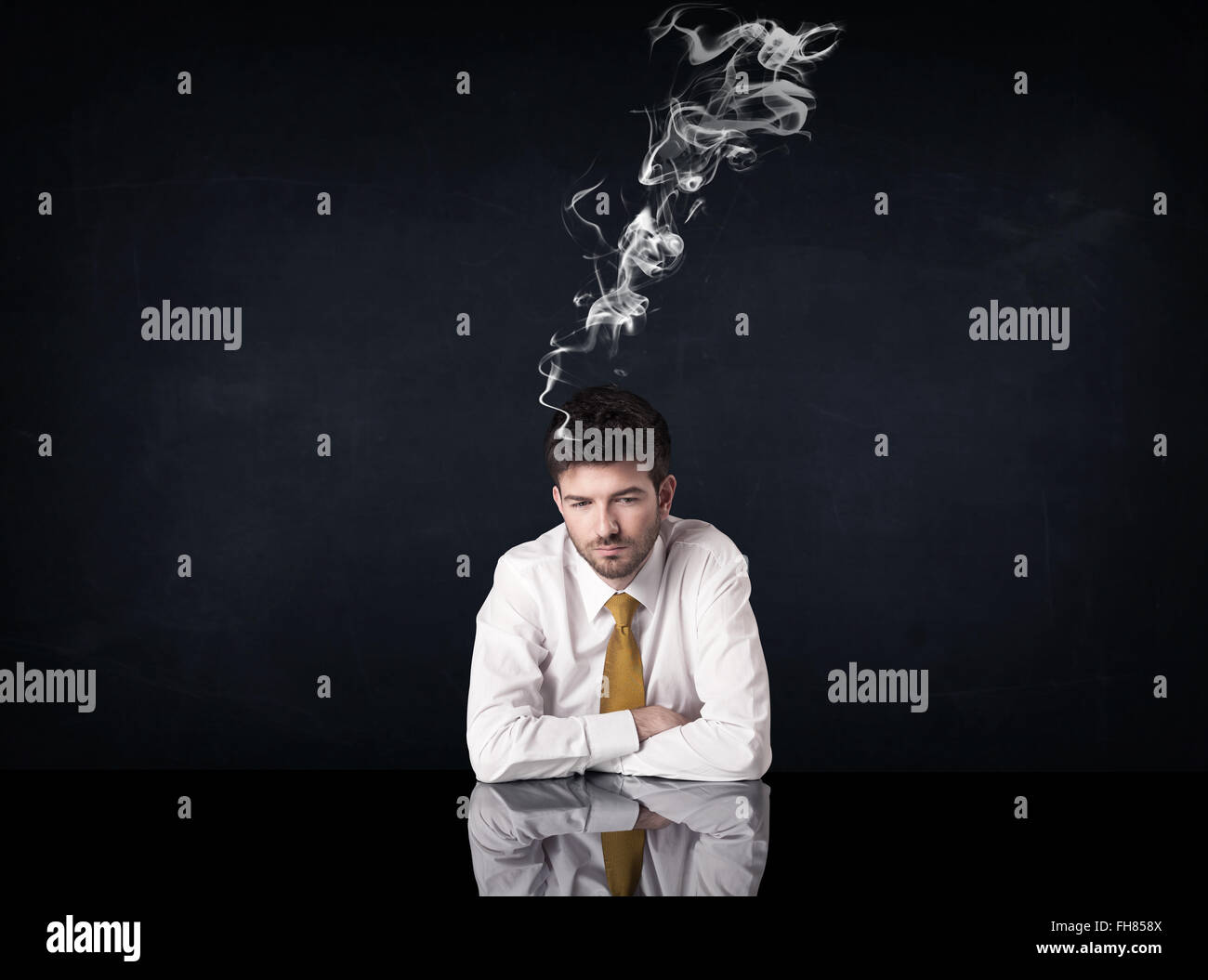Depressed businessman with smoking head Stock Photo - Alamy