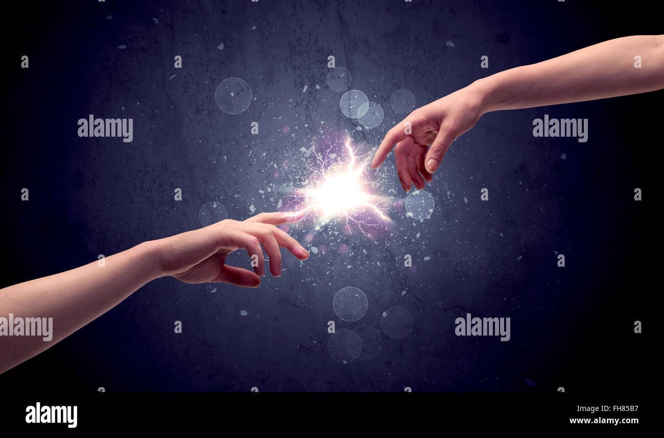 Hands reaching to light a spark Stock Photo - Alamy