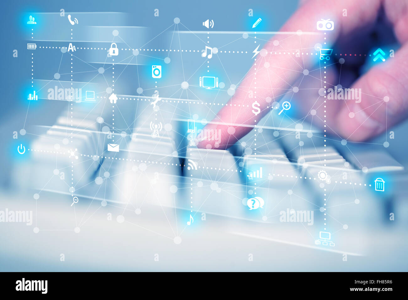 Hand pressing keyboard with high tech media icons Stock Photo - Alamy