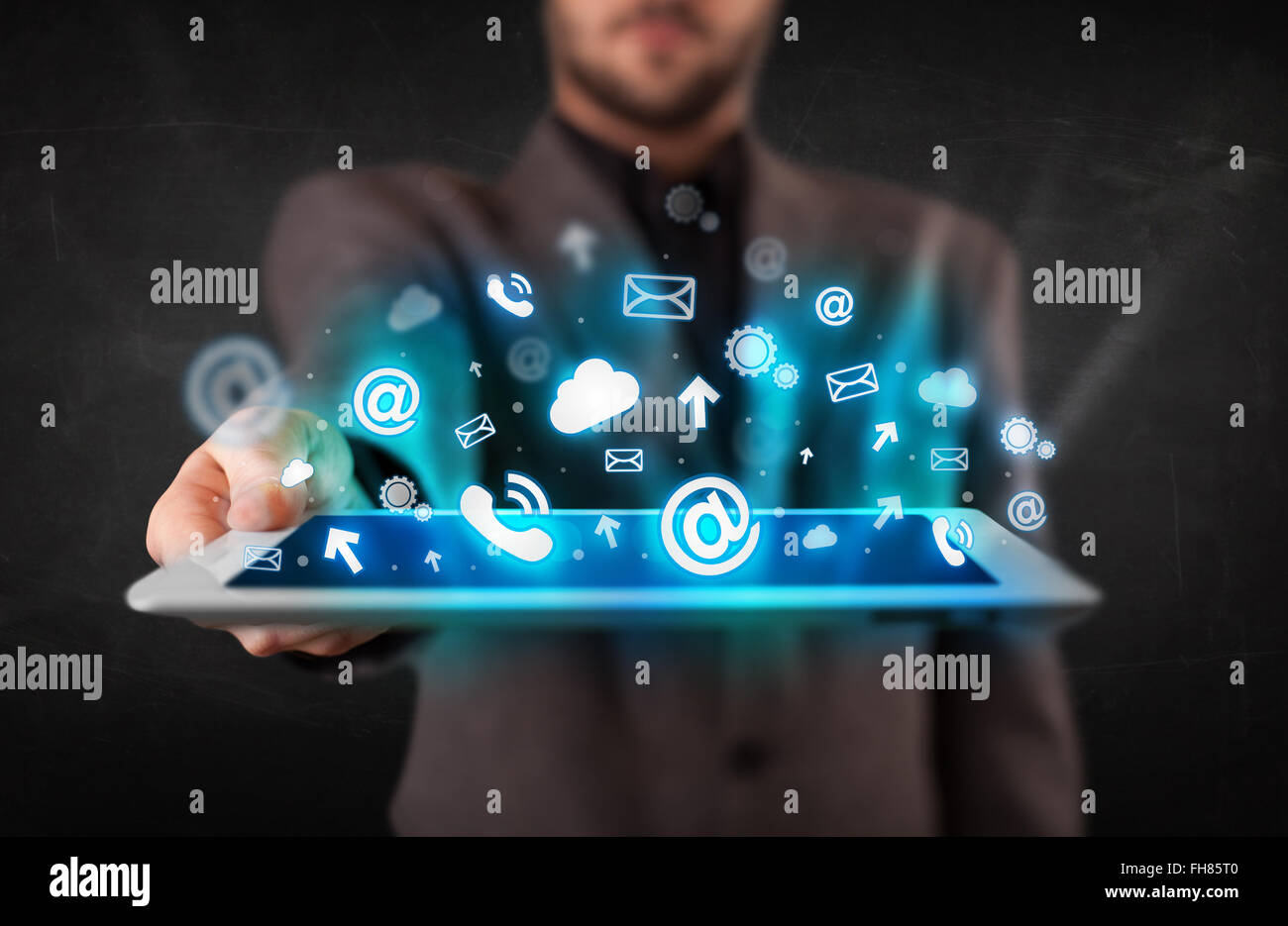 Person holding a tablet with blue technology icons and symbols Stock ...