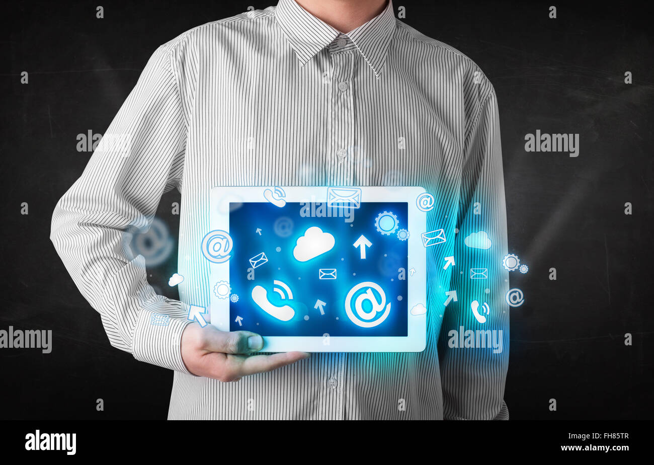 Person holding a tablet with blue technology icons and symbols Stock ...