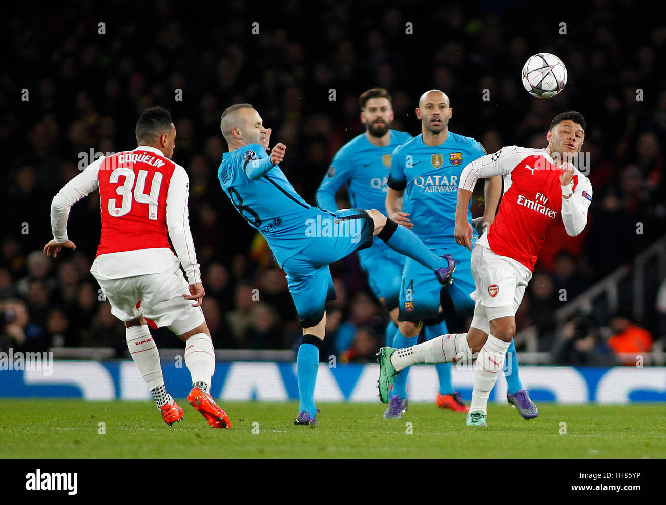 London, UK. 23rd Feb, 2016. Andres Iniesta of Barcelona and Alex Oxlade ...