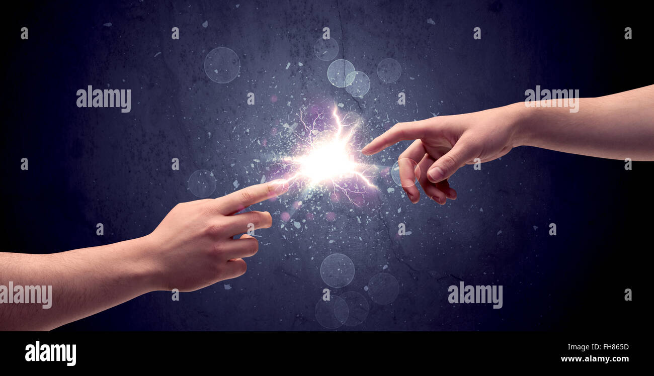 Hands reaching to light a spark Stock Photo - Alamy