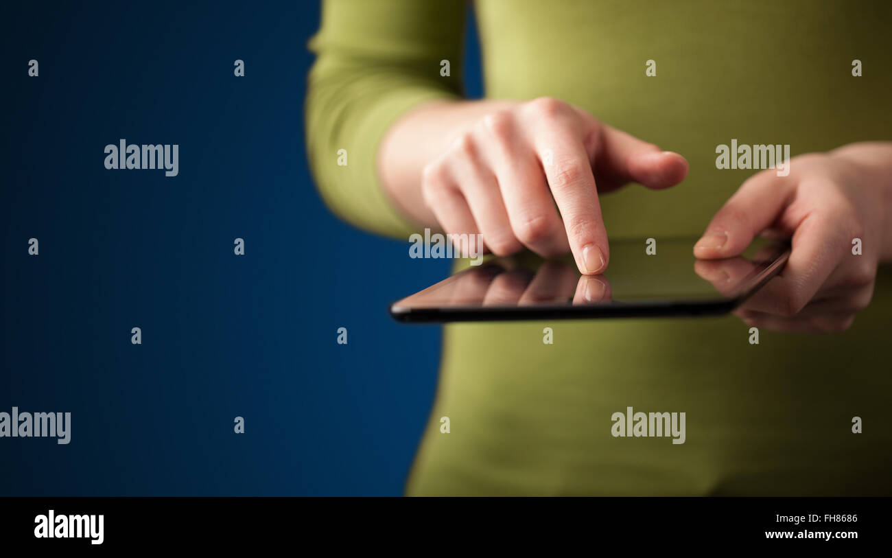 Close up of hand holding digital touchpad tablet device Stock Photo - Alamy