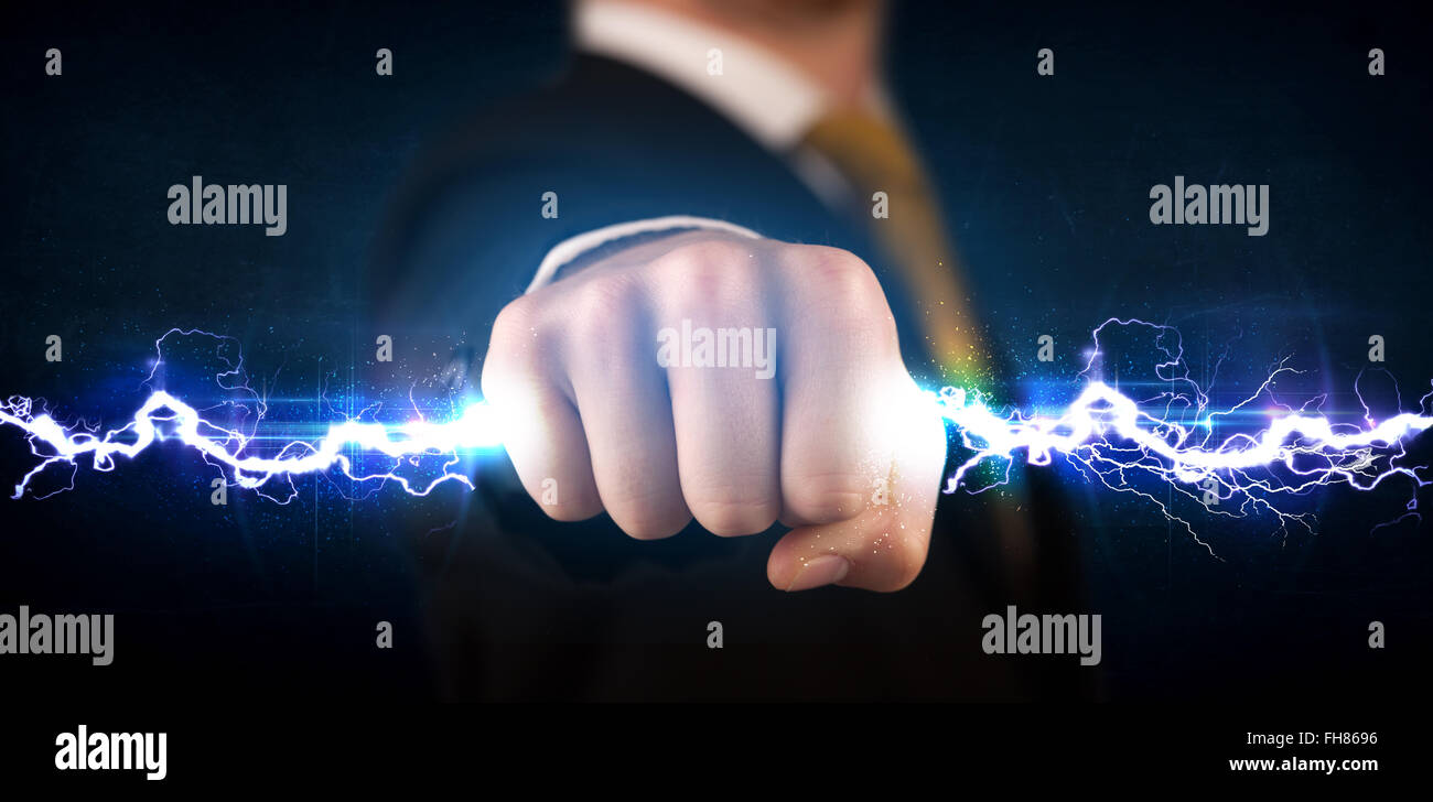 Business man holding electricity light bolt in his hands Stock Photo ...