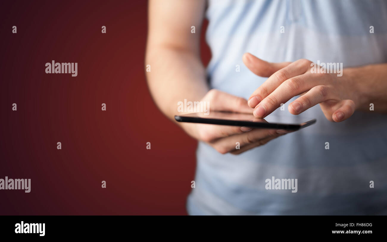 Close up of hand holding digital touchpad tablet device Stock Photo - Alamy
