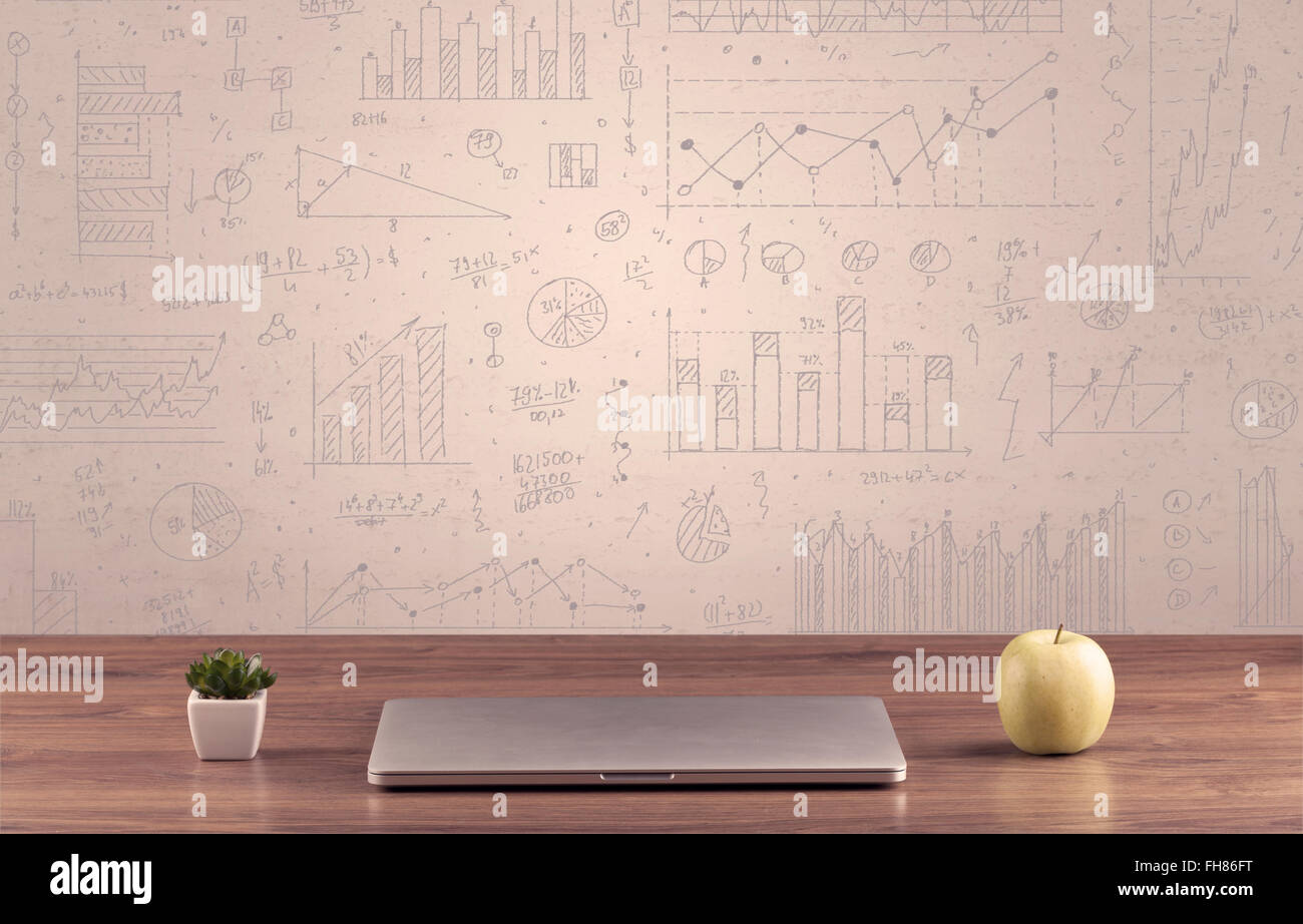 Graph charts and designer office desk Stock Photo - Alamy