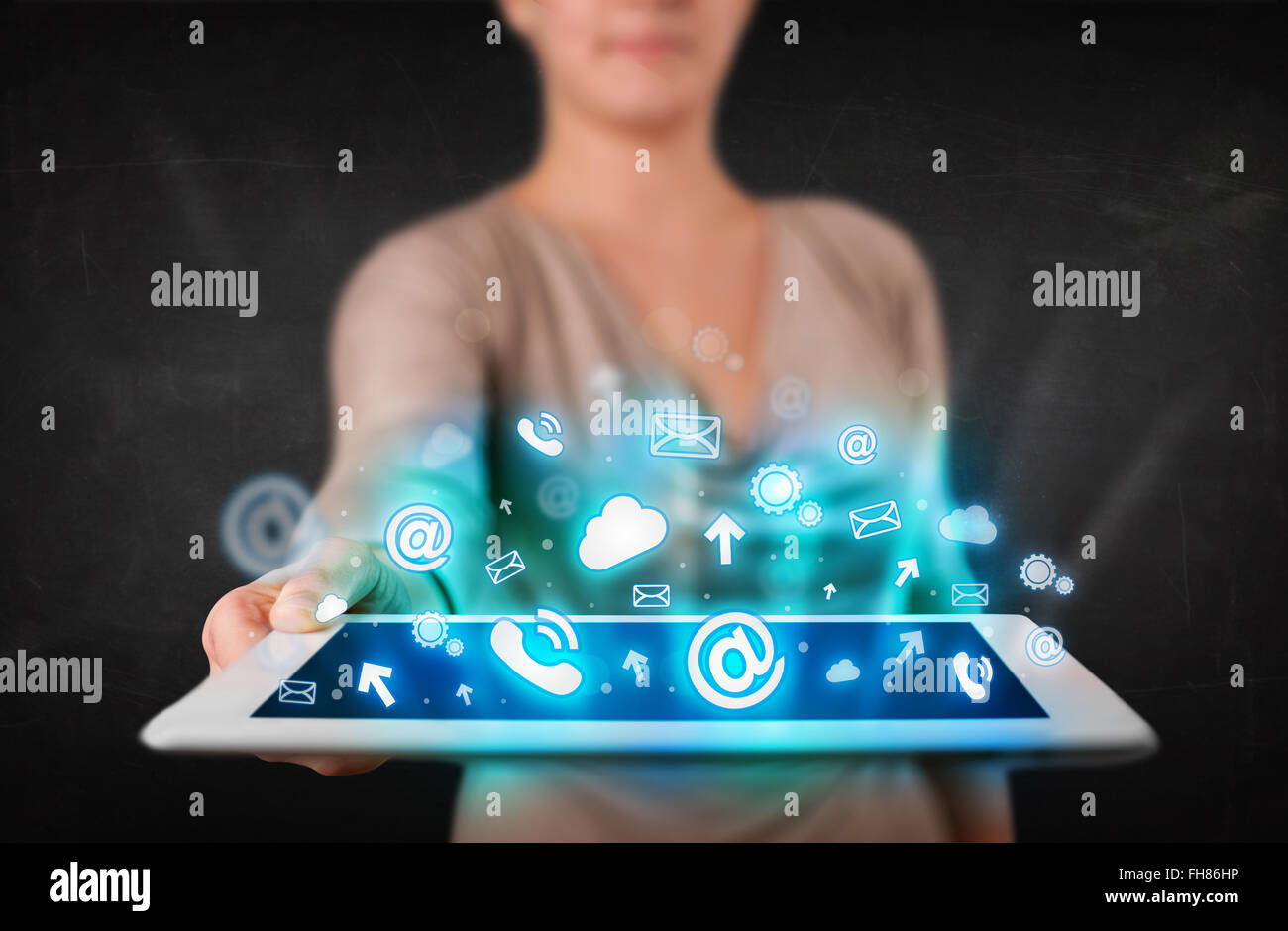 Person holding a tablet with blue technology icons and symbols Stock ...