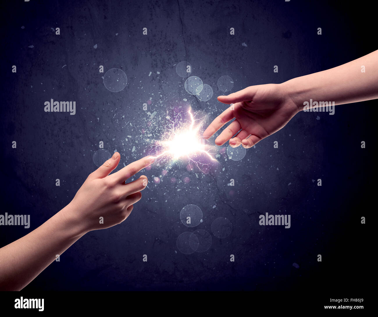 Hands reaching to light a spark Stock Photo - Alamy