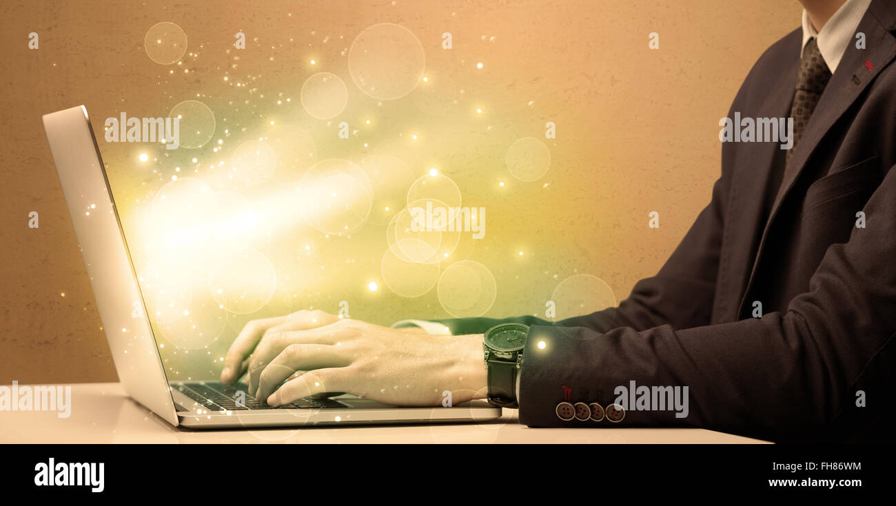 Businessman working fast on laptop Stock Photo - Alamy