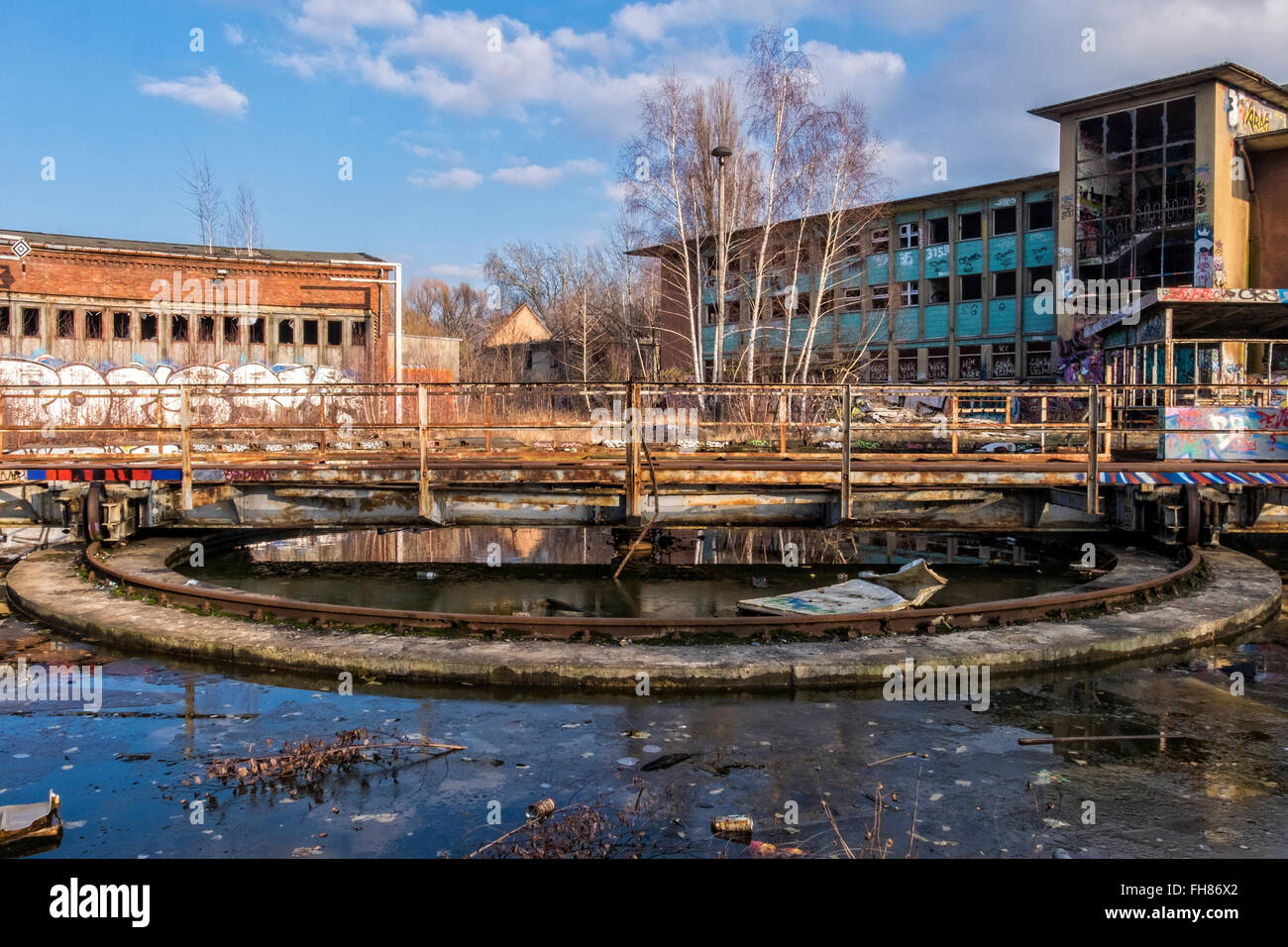 Disused former freight rail yard buildings and rusty turntable ...