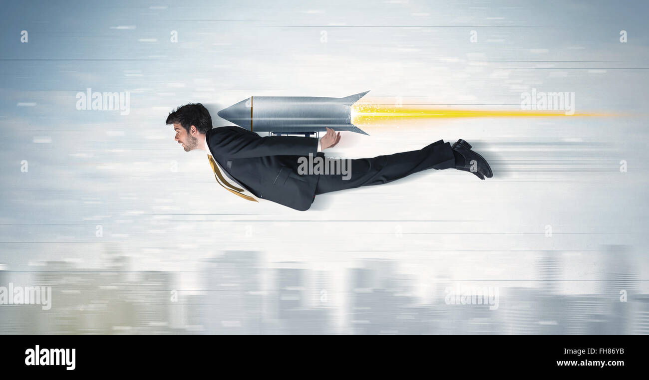 Superhero business man flying with jet pack rocket above the city Stock ...