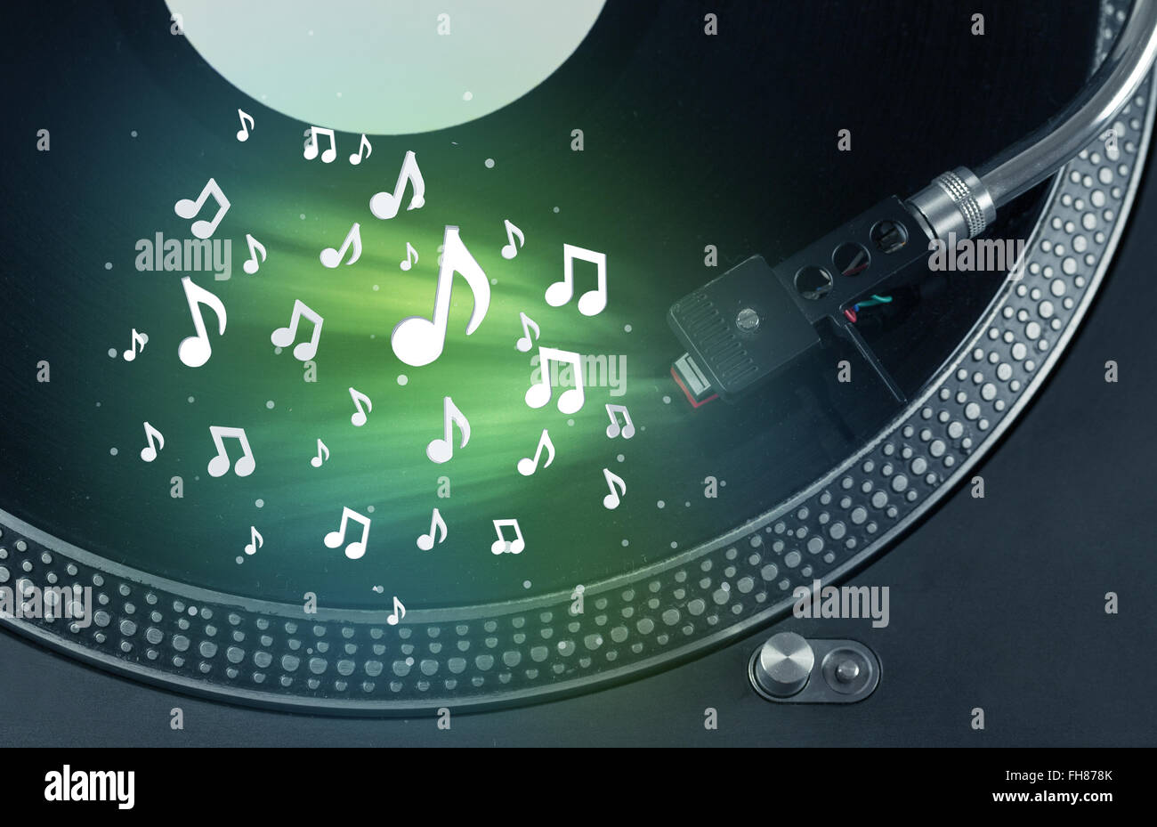 Turntable playing music with audio notes glowing Stock Photo - Alamy