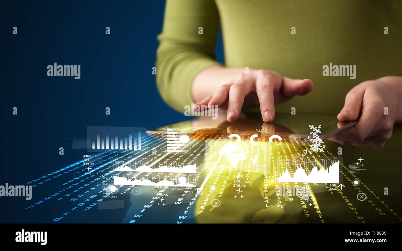 Hand holding touchpad tablet with business market graphs Stock Photo ...