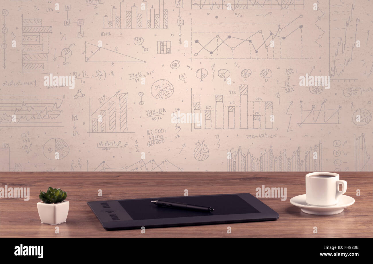 Graph charts and designer office desk Stock Photo - Alamy