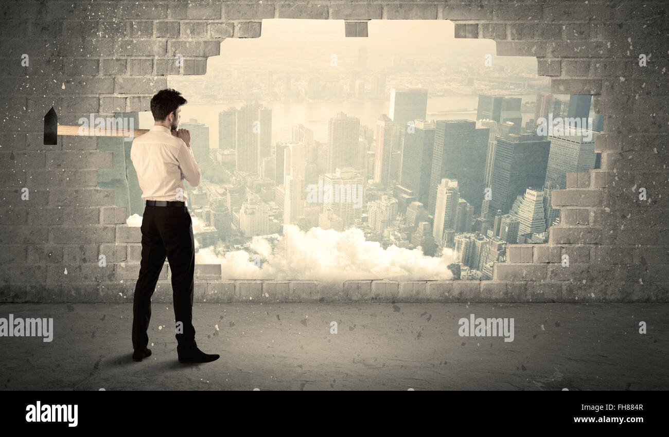 Business man hitting wall with hammer on city view Stock Photo - Alamy