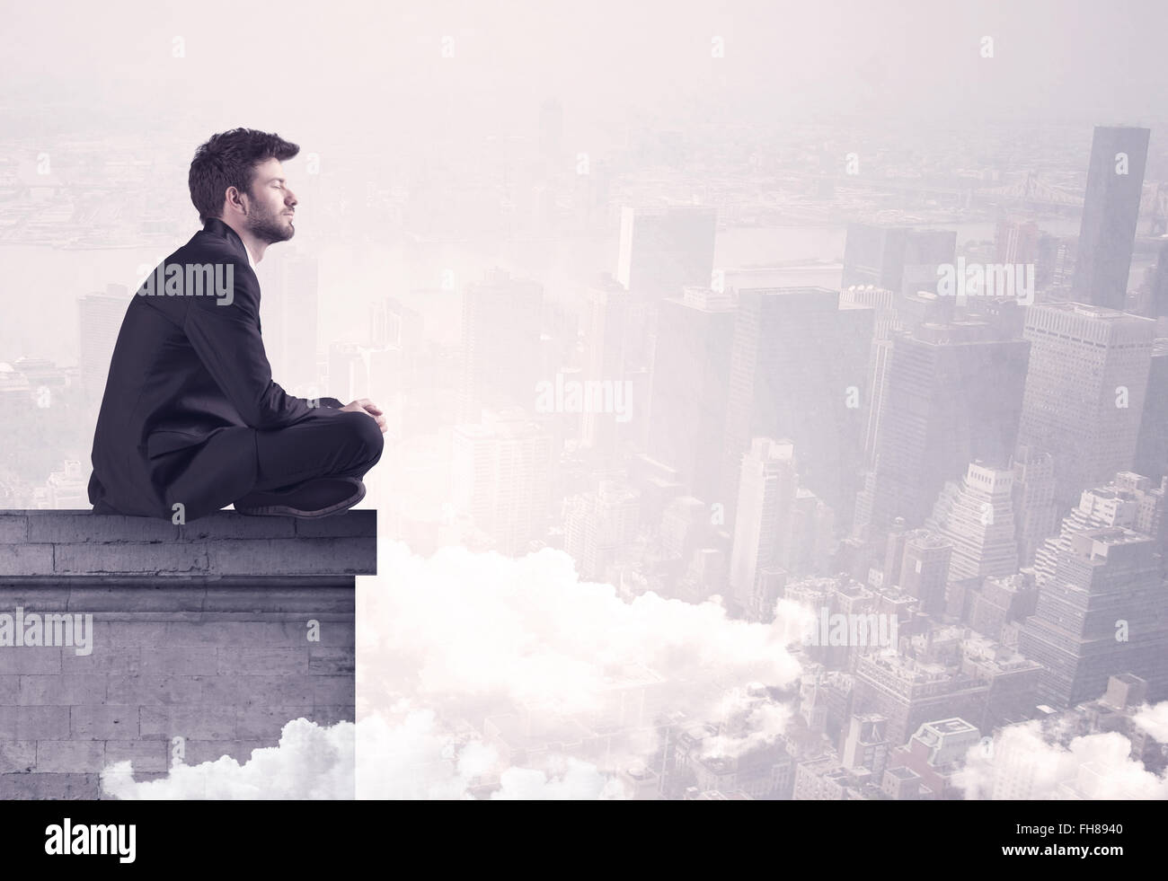 Sales person sitting on building edge in city Stock Photo - Alamy
