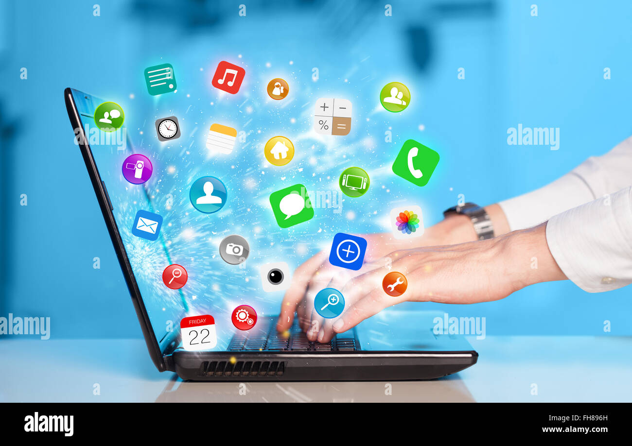 Hand pressing modern laptop with mobile app icons and symbols Stock ...
