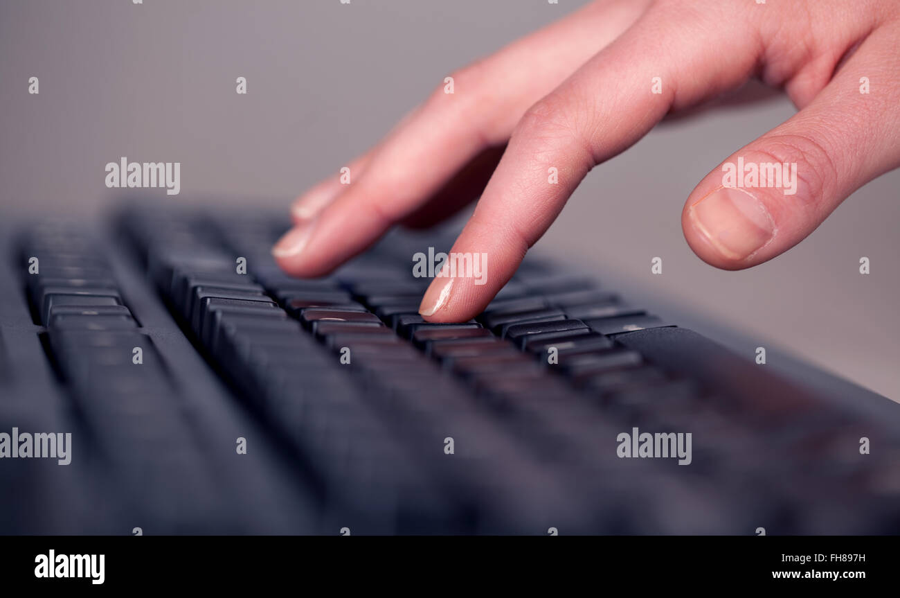 Close up of hand pressing keyboard buttons Stock Photo - Alamy