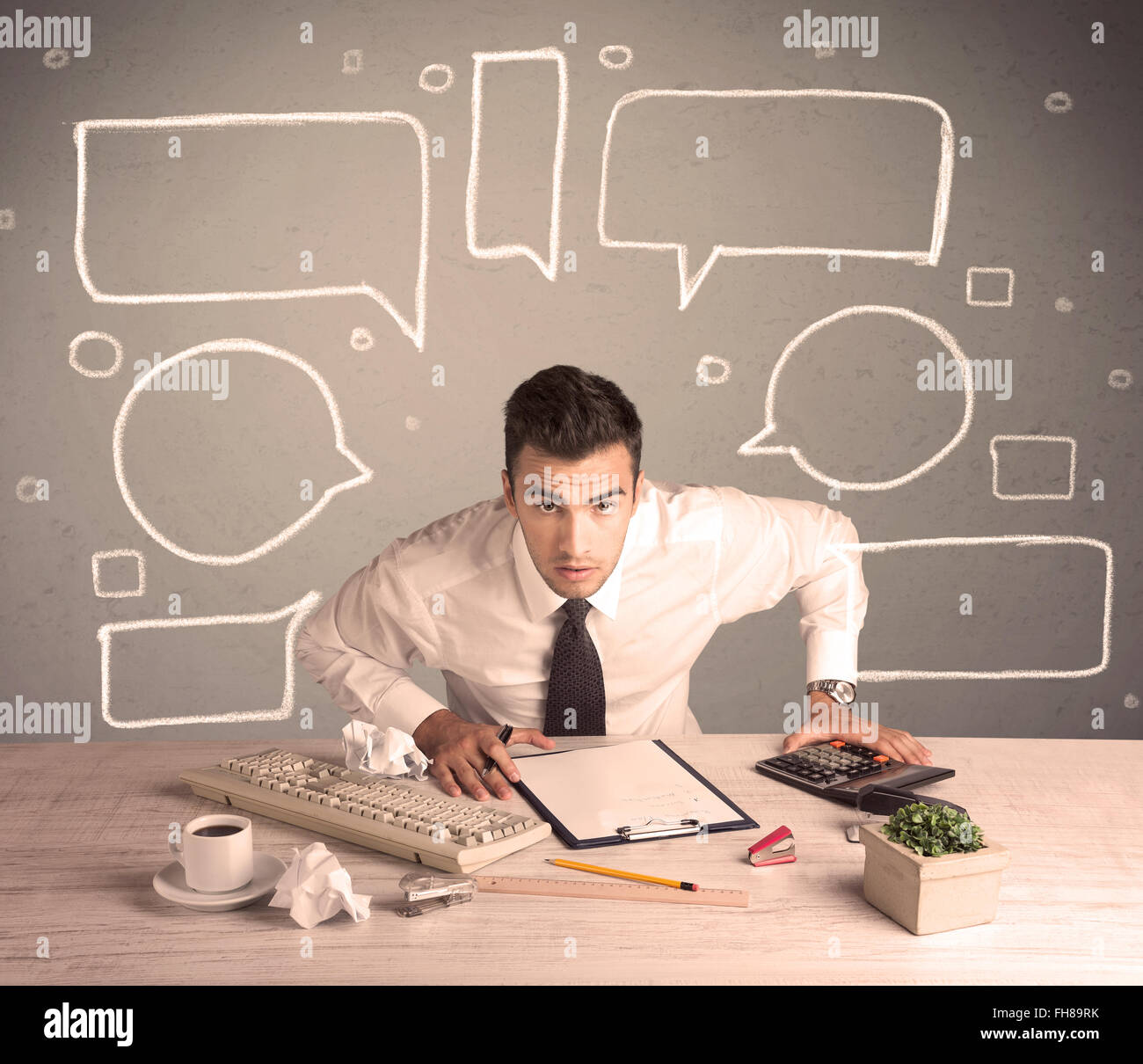 Busy office worker with drawn text bubbles Stock Photo - Alamy