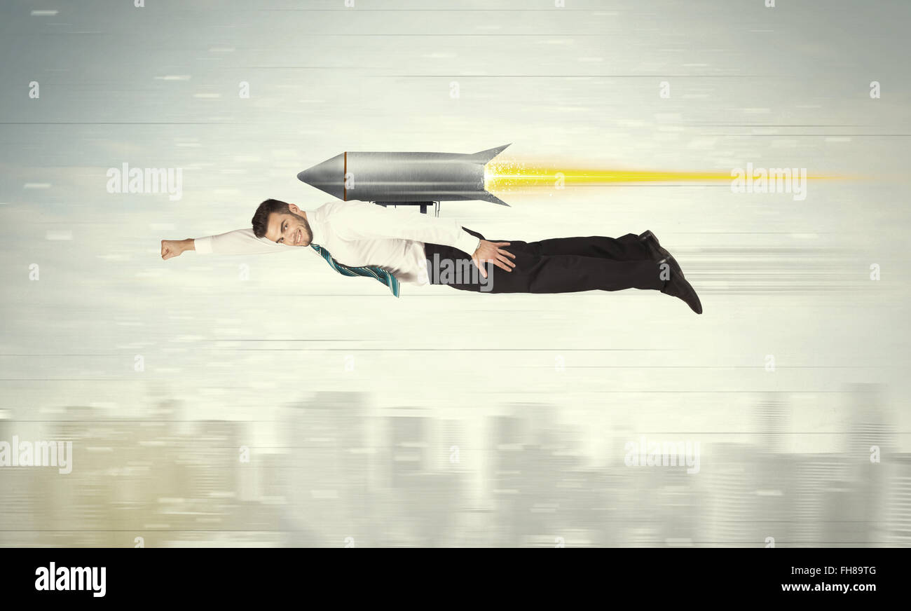 Superhero business man flying with jet pack rocket above the city Stock ...