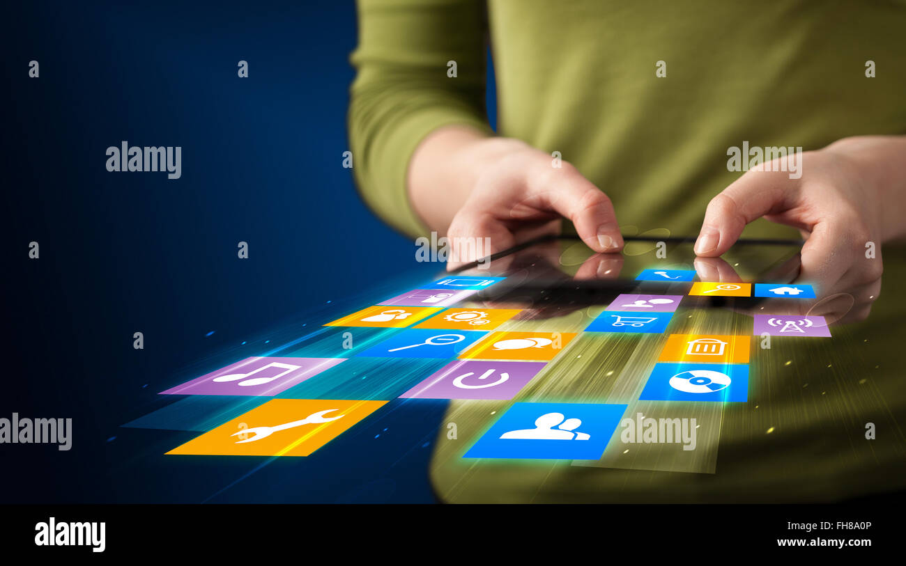 Hand holding tablet device with media application Stock Photo - Alamy