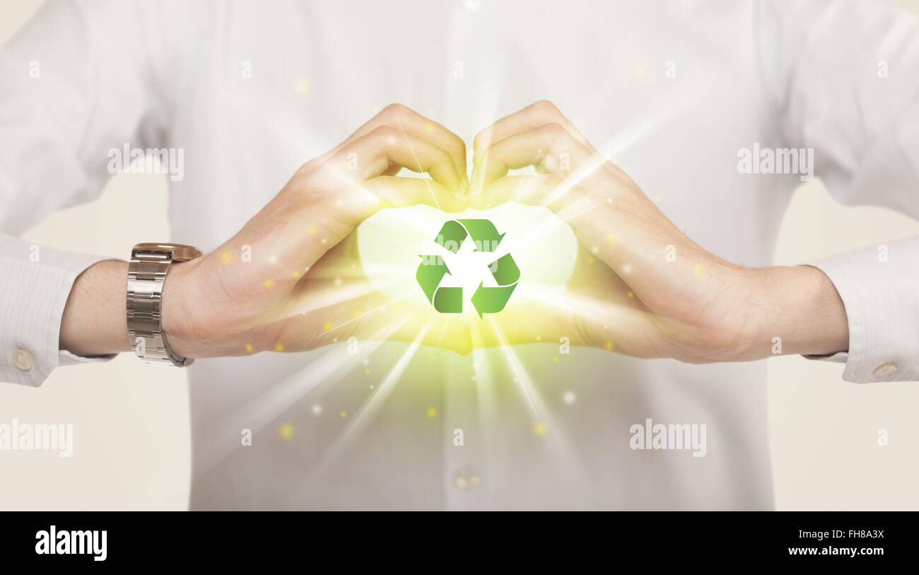 Hands creating a form with recycling sign Stock Photo - Alamy