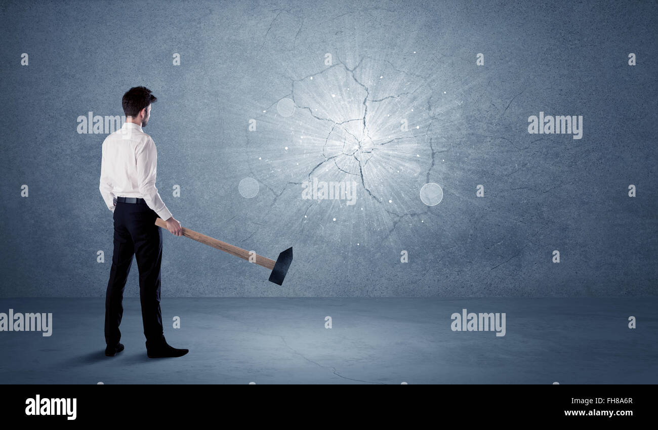 Business man hitting wall with a hammer Stock Photo - Alamy
